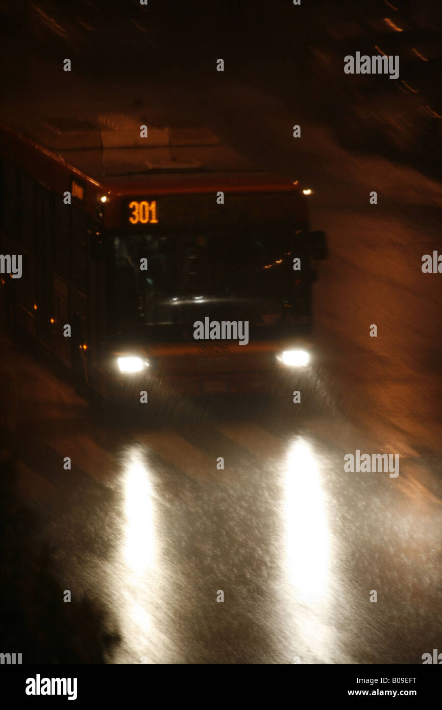 fast bus driving in heavy rain at night in town Stock Photo - Alamy