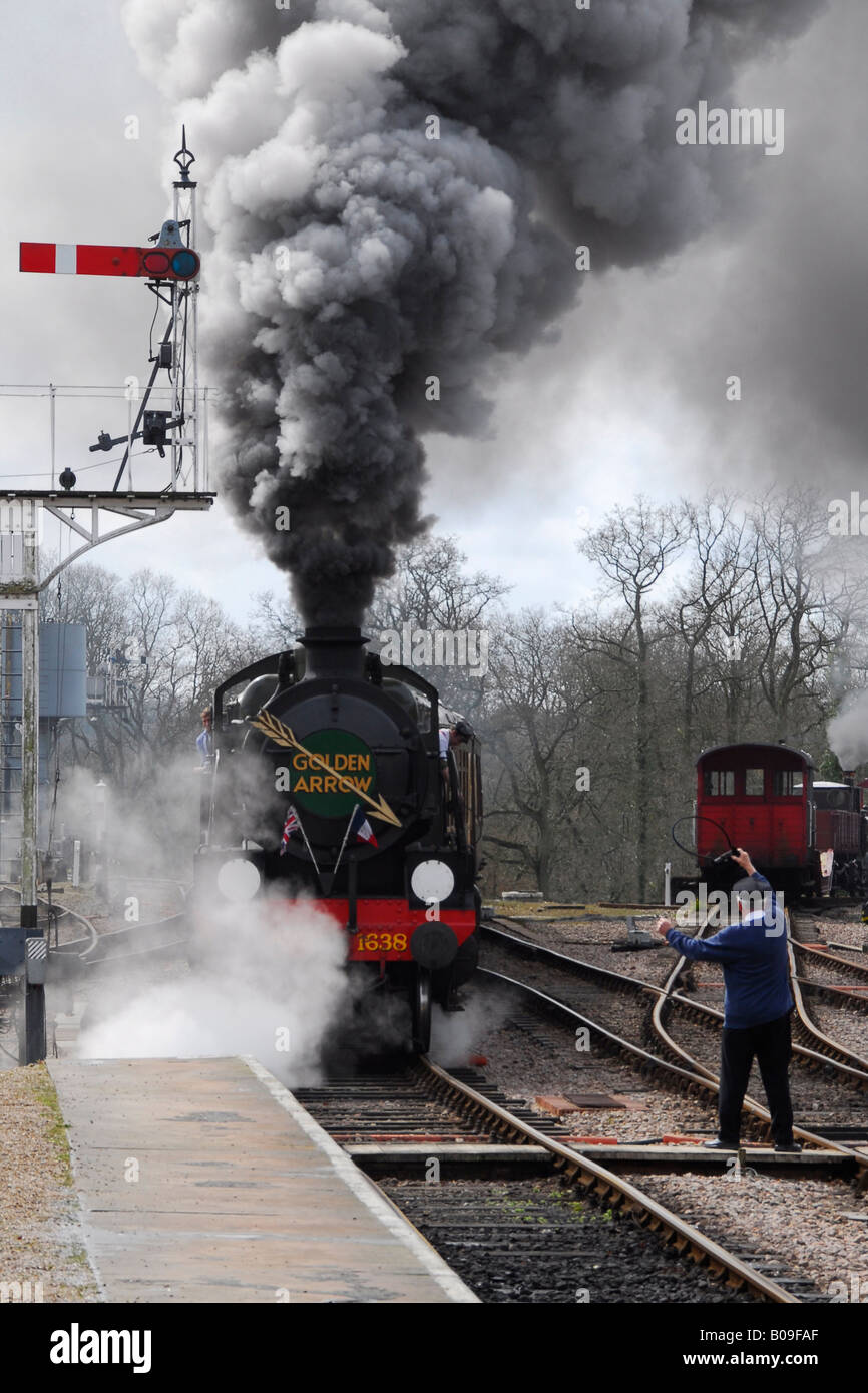 Steam loco on horizon over bridge across field Stock Photo - Alamy