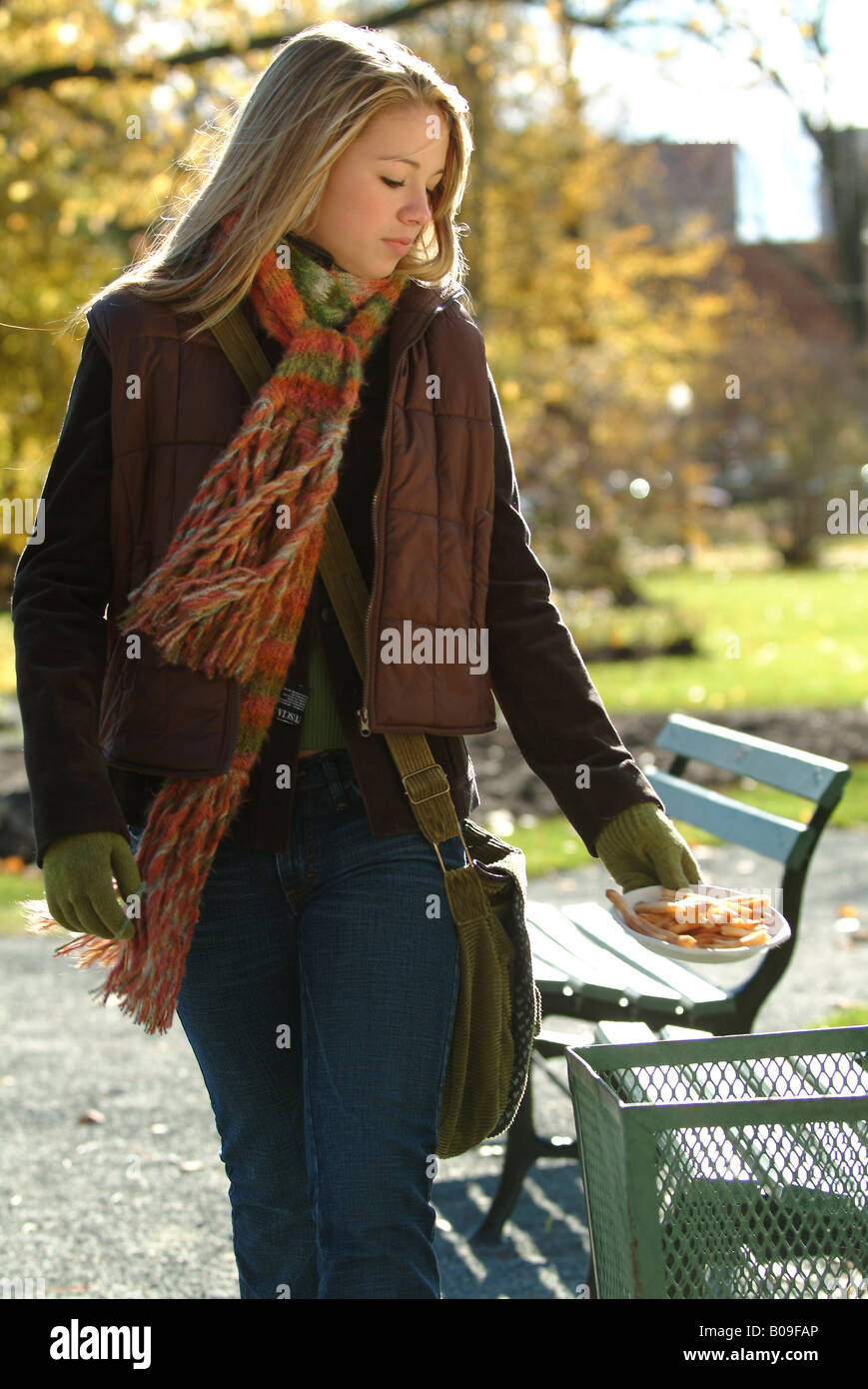 A young woman making a healthy decision by throwing out her french ...