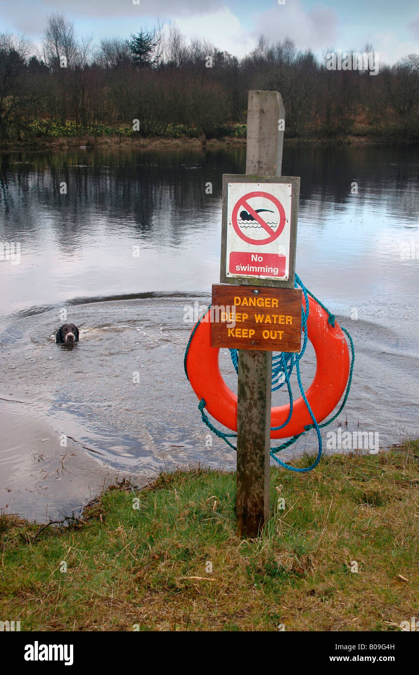 A warning sign with a life belt, warning of the dangers of deep water ...