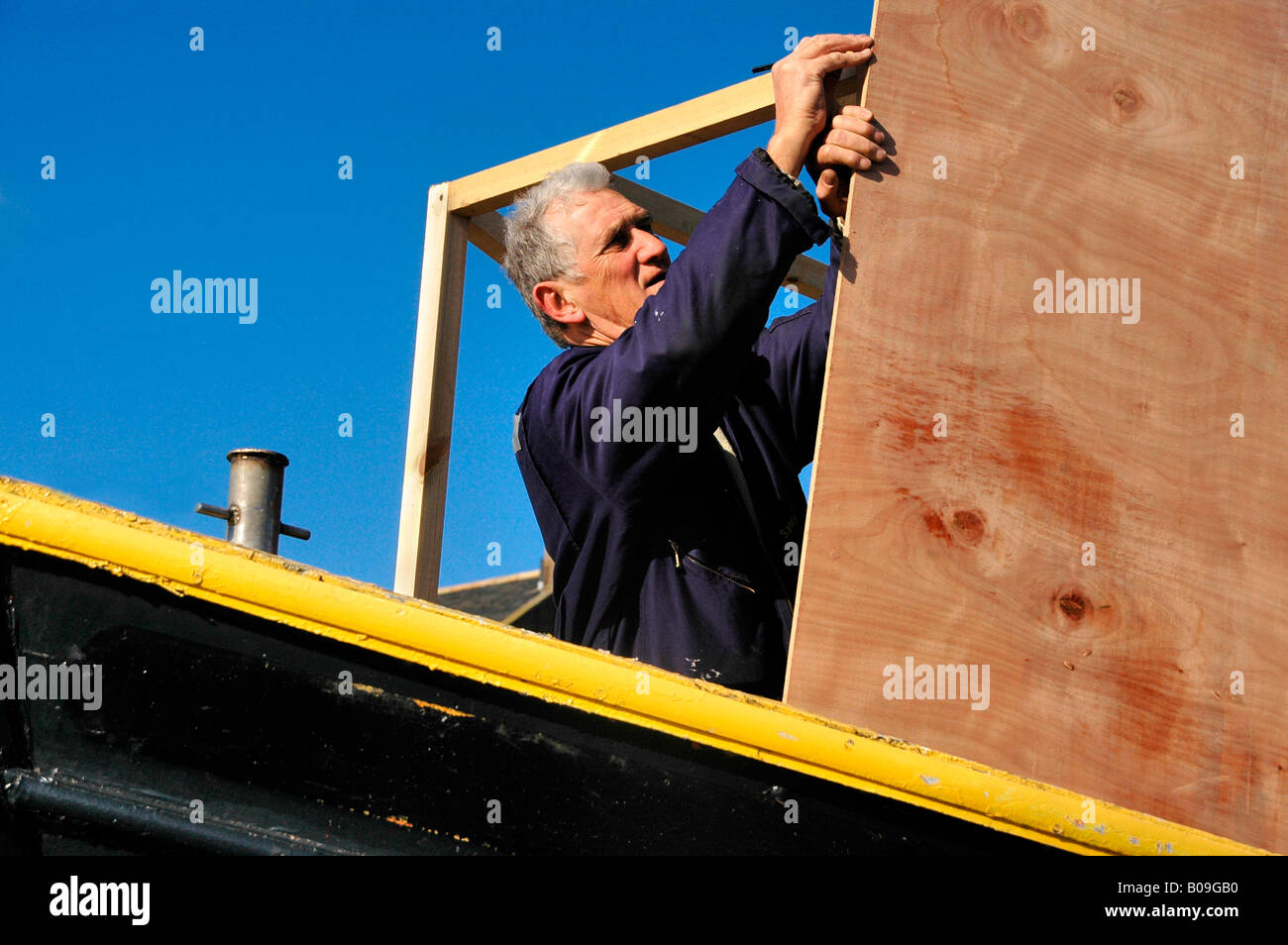 Man fixing boat hi-res stock photography and images - Alamy