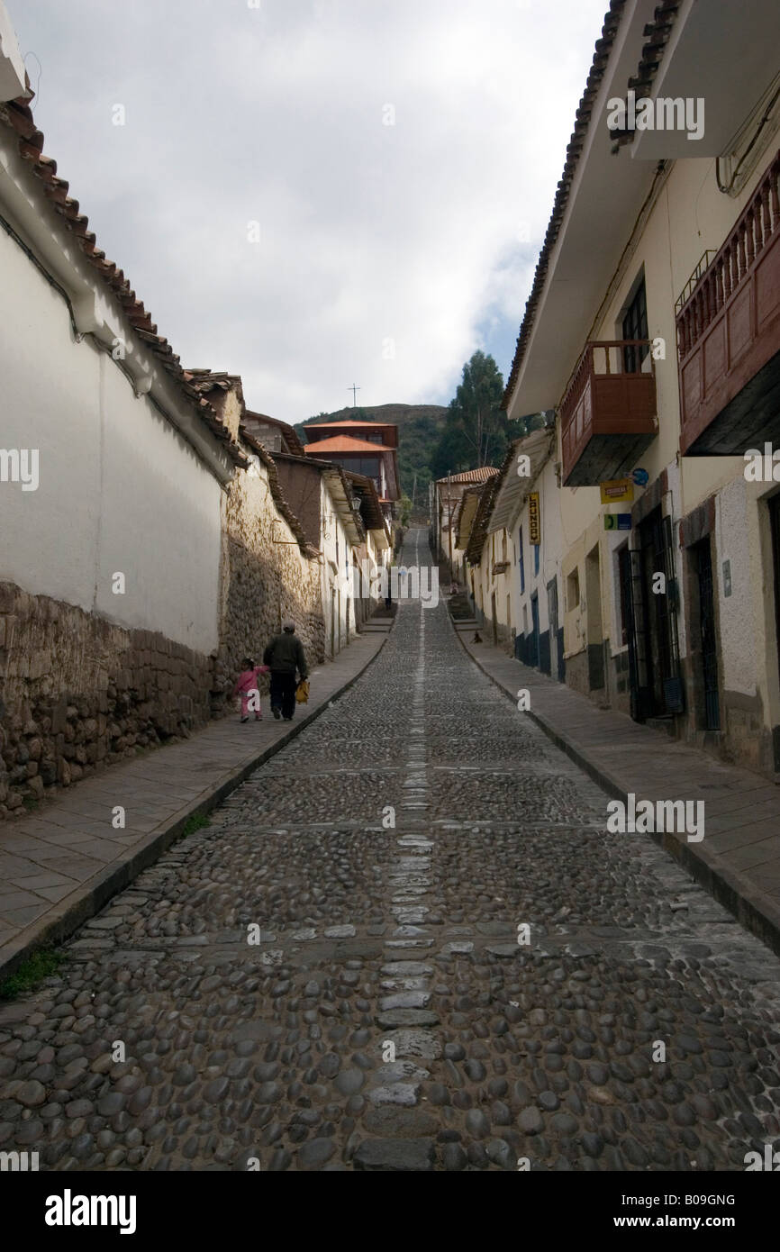 South America - Peru. Local residents walking up cobblestone street in ...