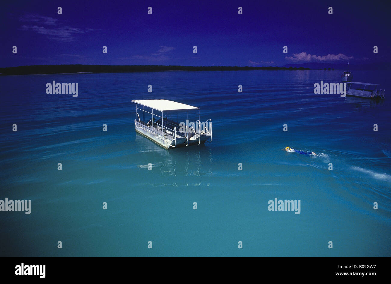 Great Barrier Reef Swimmer in deep blue sea Boat Low Isles Deep blue ...