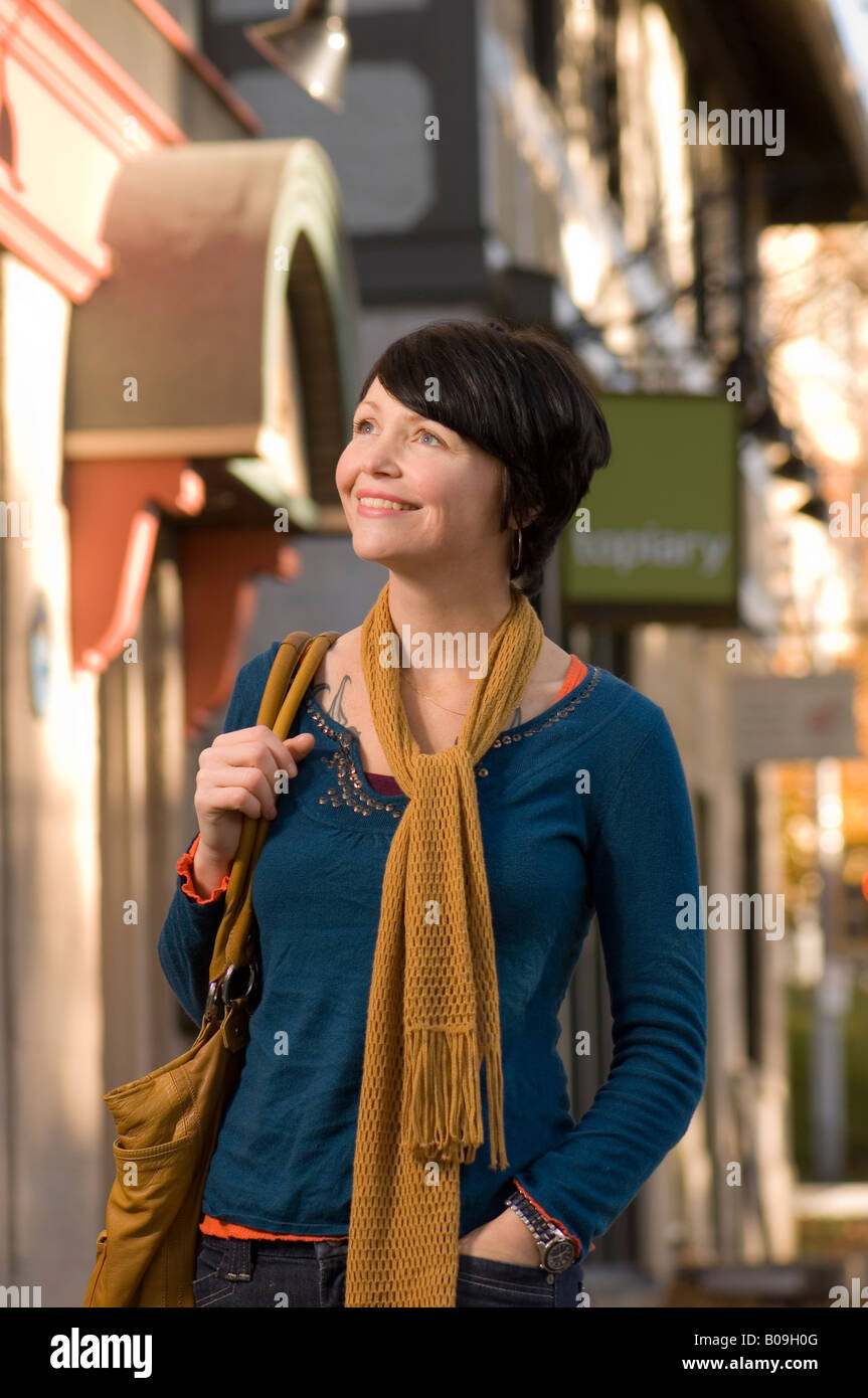 A woman walking down a quiet street Stock Photo - Alamy