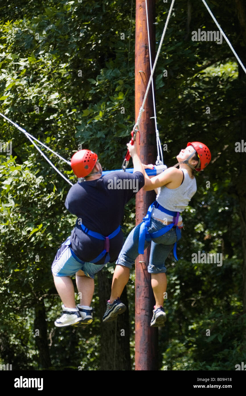 Teenage Girl and Boy Participating In Ropes Team Building Course Mount ...