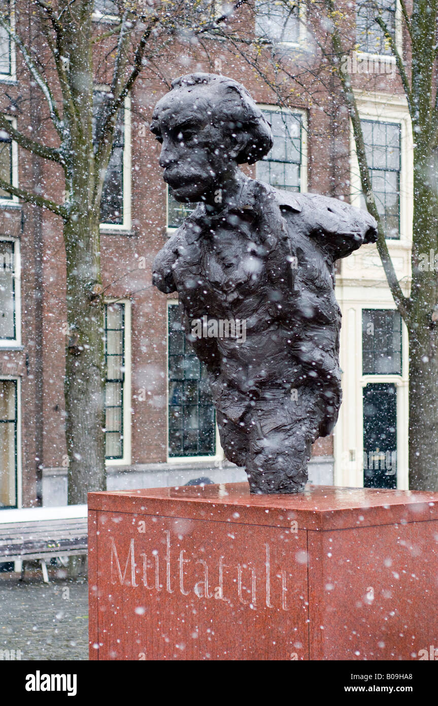 Amsterdam, statue of Multatuli in falling snow, in a square over Singel ...