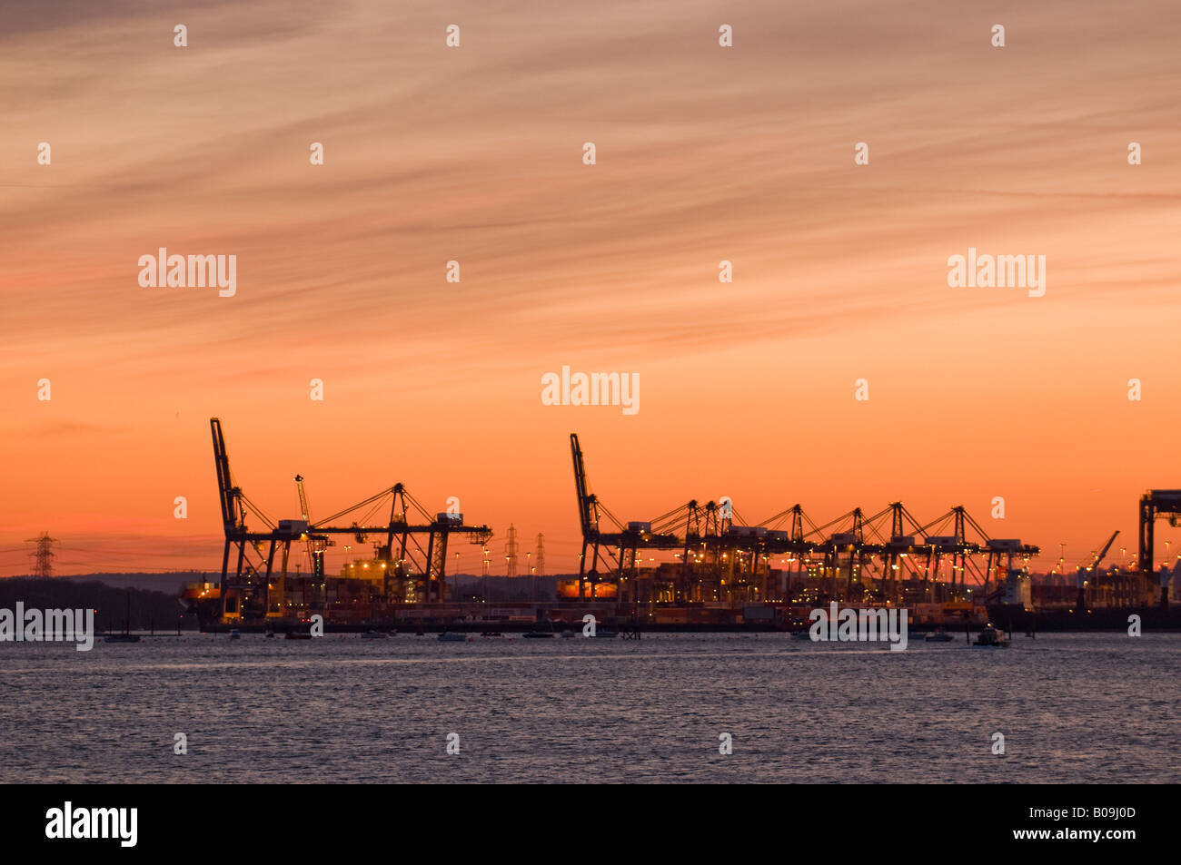 England Southampton dockyard cranes at sunset in the container port ...