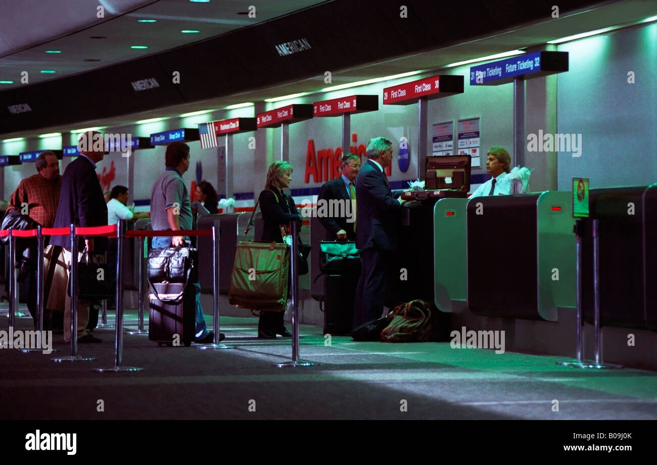 Air Travelers in line at the check in counter for American Airlines at ...