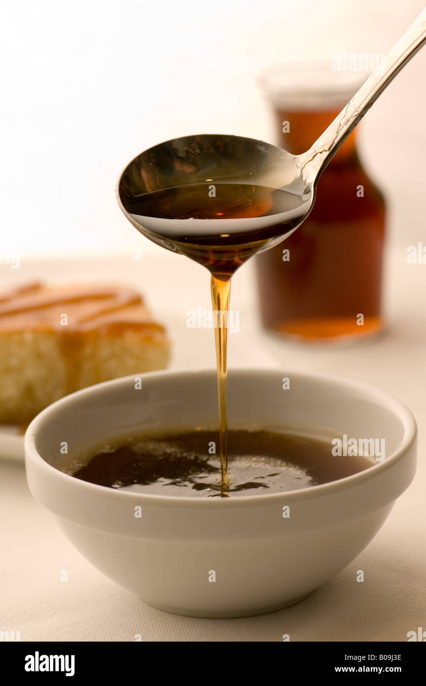 Syrup dripping from a ladle Stock Photo - Alamy
