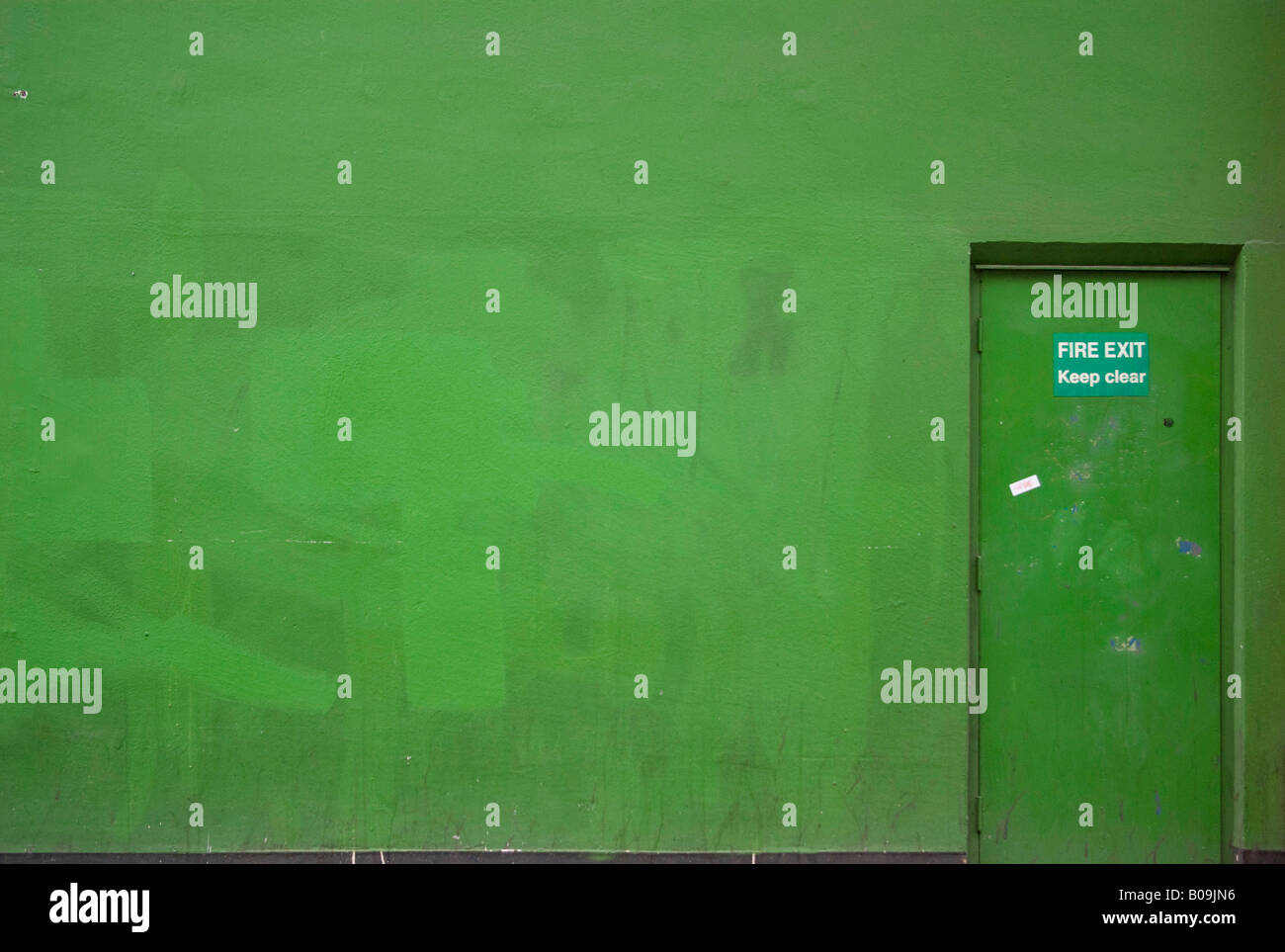 Green Fire Exit door and wall Stock Photo - Alamy