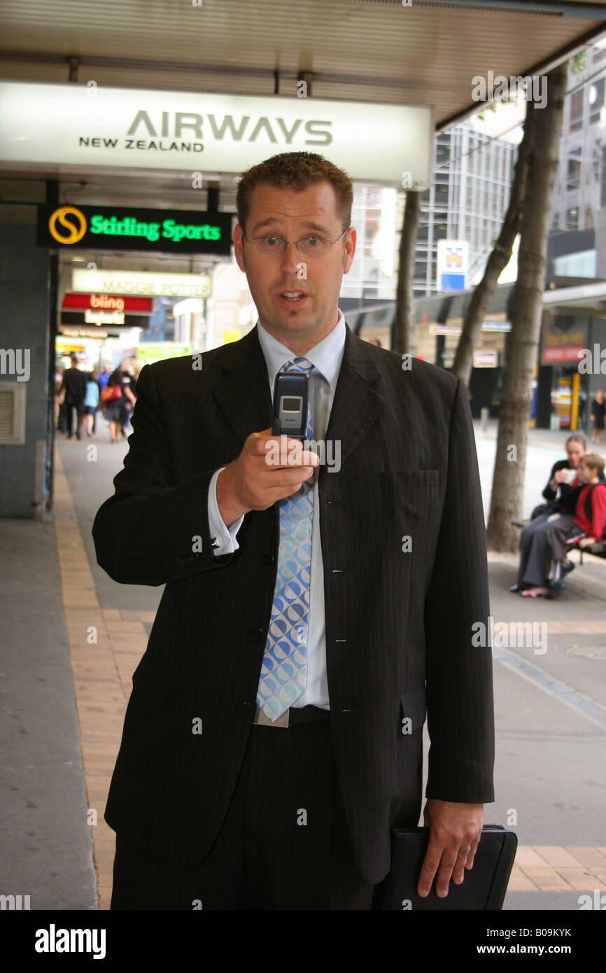 Business man in city using his cellphone Stock Photo - Alamy