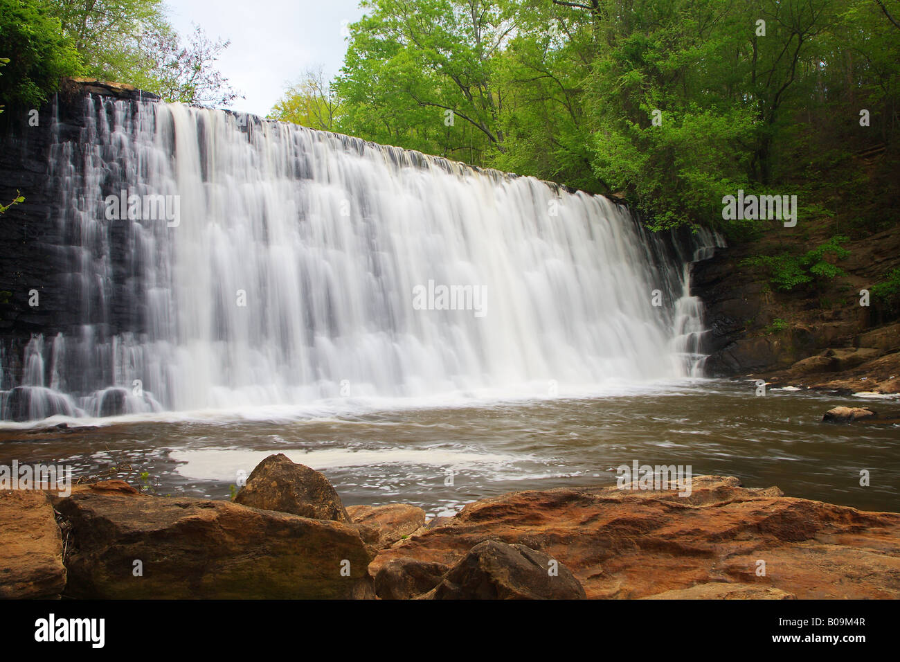 Water pours over the old historic, antebellum Roswell Mill dam located ...