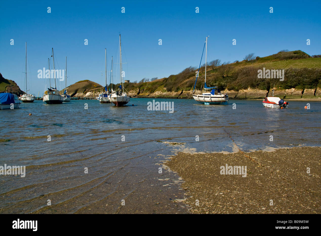 On the shingle beach between the boats at Watermouth Cove North Devon ...