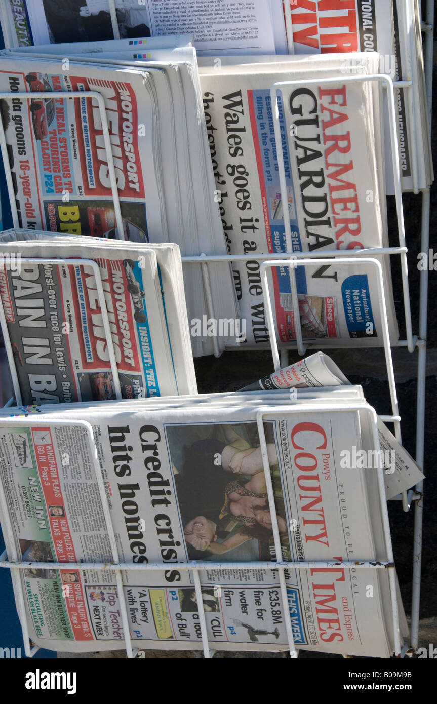 UK British local regional and national newspapers in rack outside ...