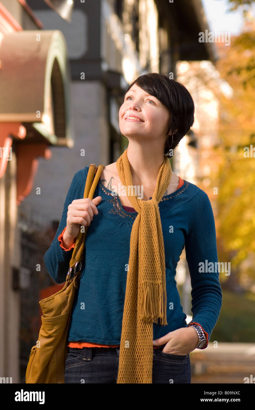 A woman walking down a quiet street Stock Photo - Alamy