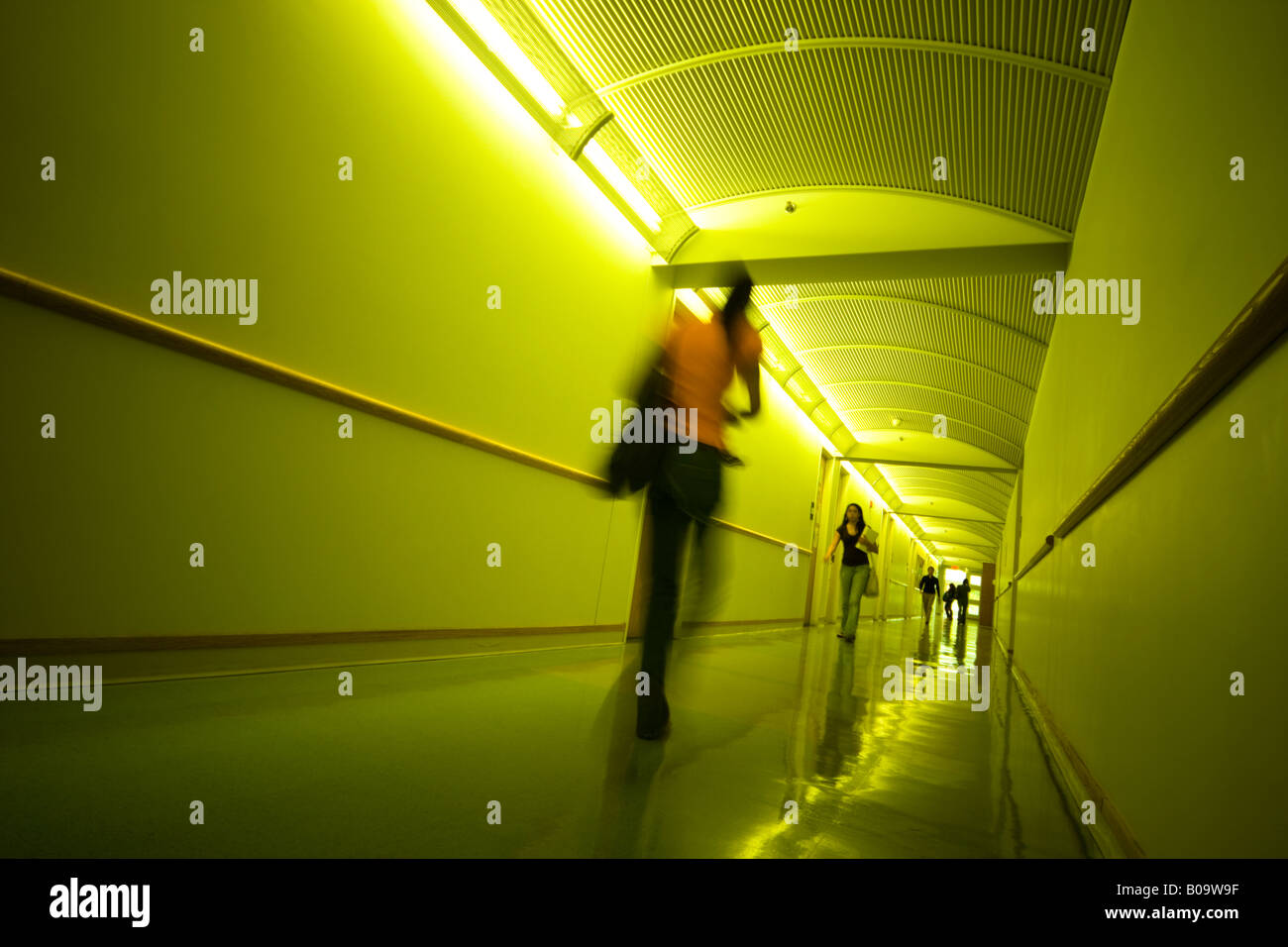 People walking down a long hallway Stock Photo - Alamy