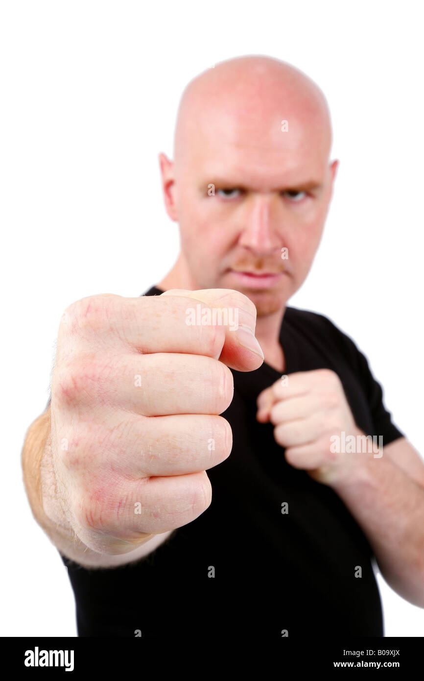 bald headed, young mean man threatening with his fist Stock Photo - Alamy