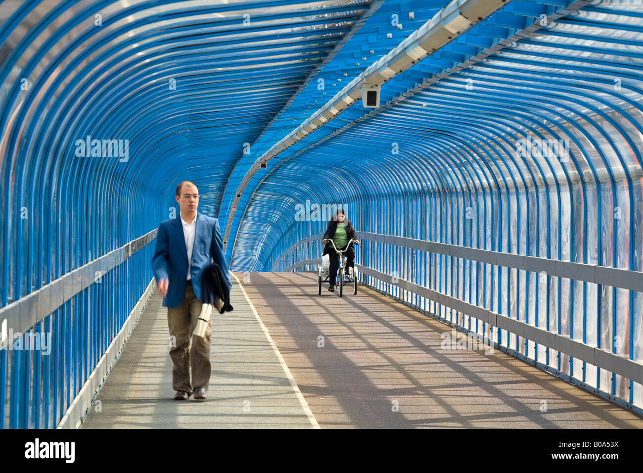 Pedestrian and cyclist on a three wheeled cycle crossing the Carter ...
