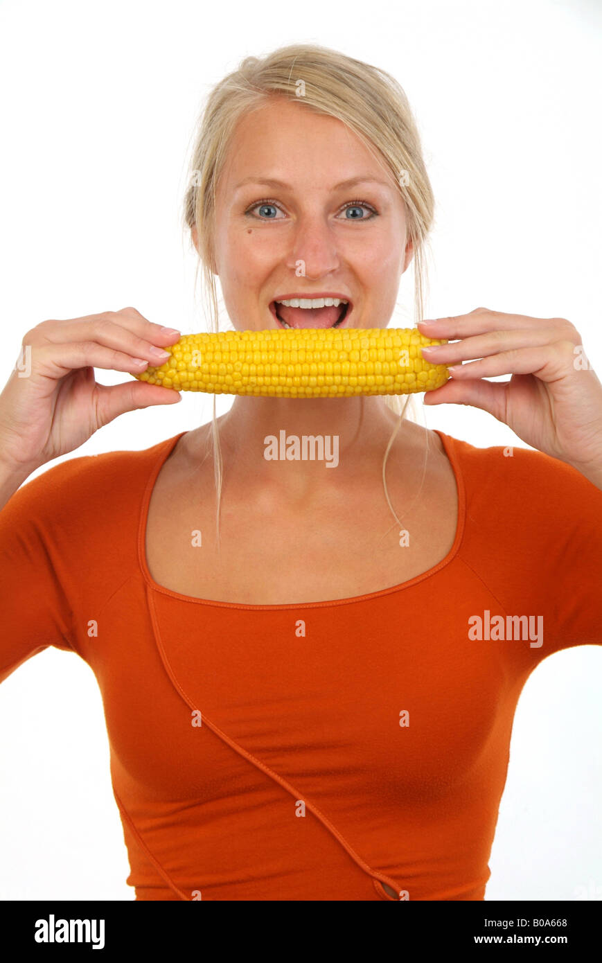 young blond woman eating a cooked maize cob Stock Photo - Alamy