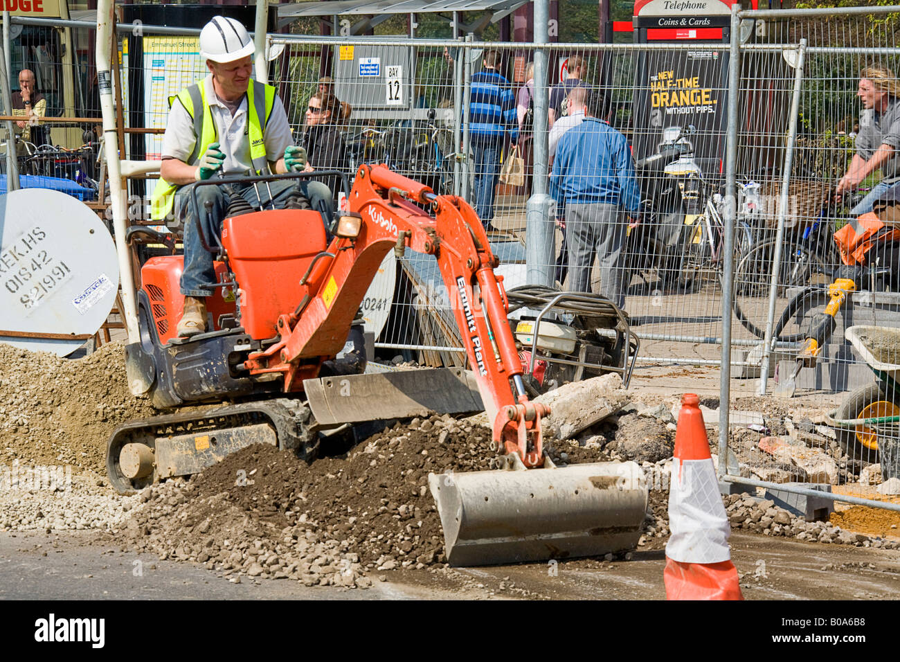 Workman using a Mini digger being used to move soil and rubble from ...