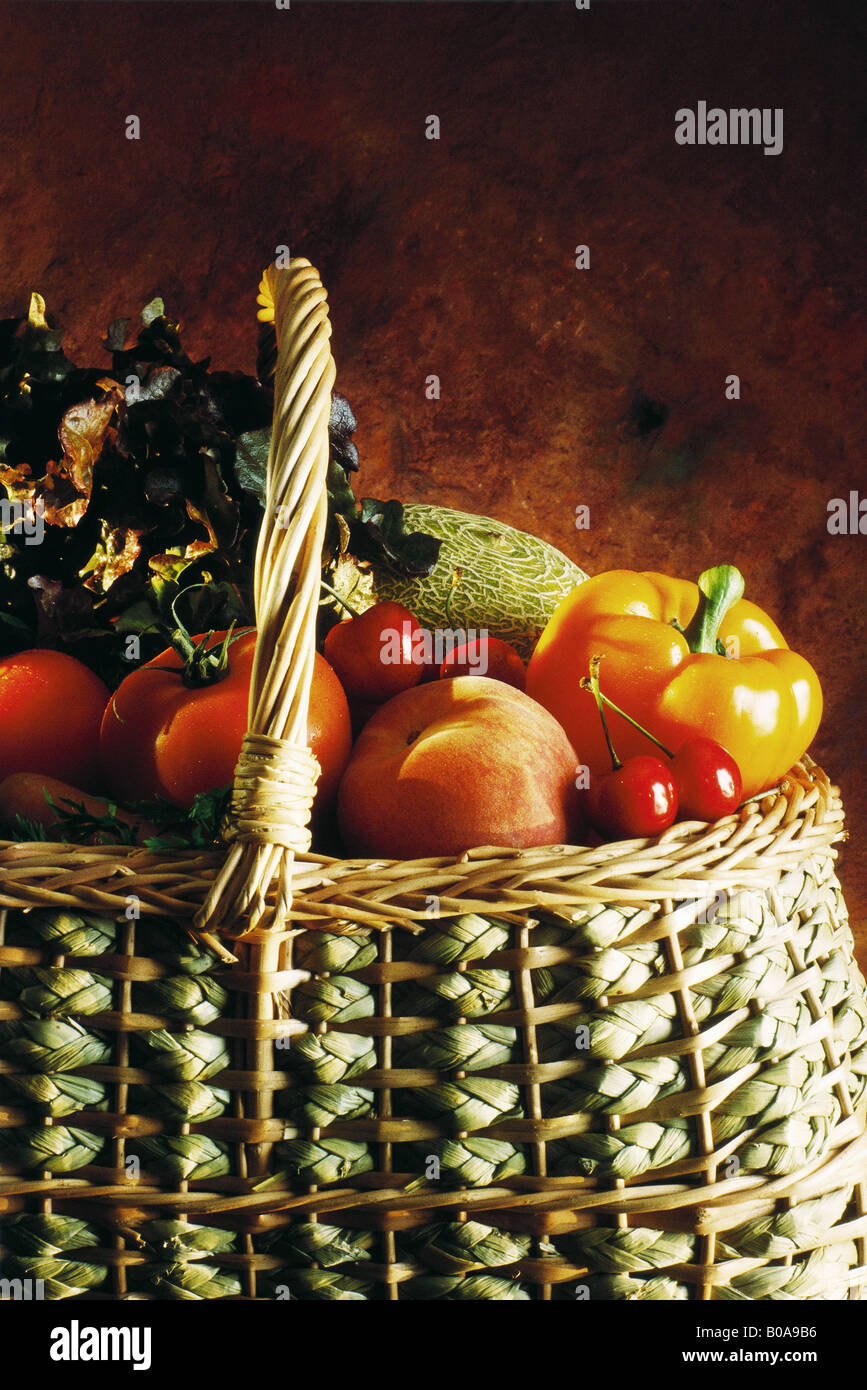 Assorted fruits and vegetables in basket, cropped view Stock Photo - Alamy