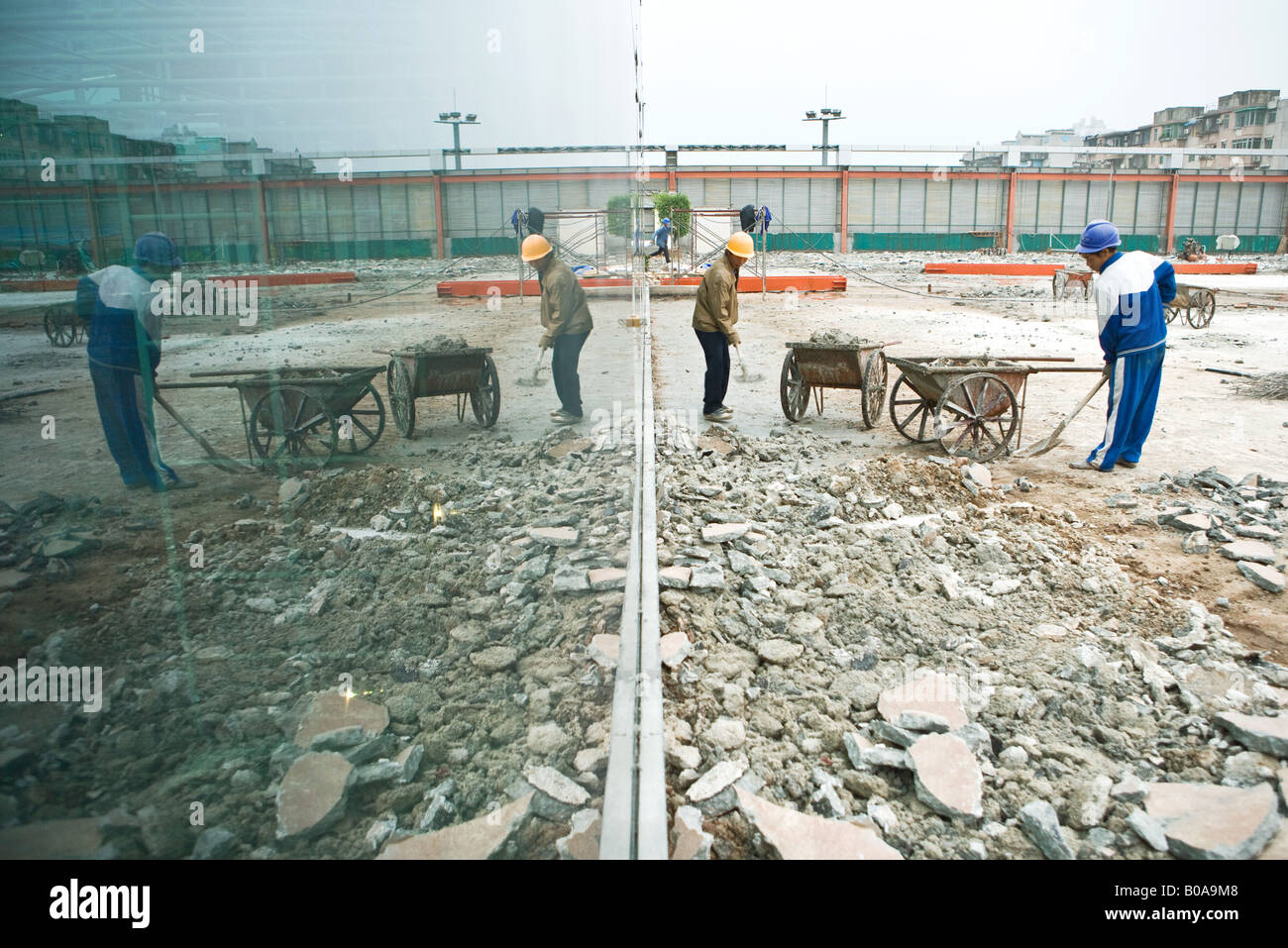 Two construction workers digging on construction site Stock Photo - Alamy