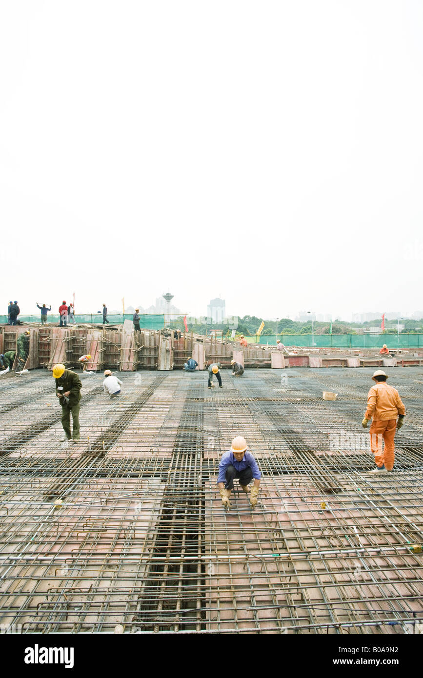 Workers building steel framework at construction site Stock Photo - Alamy