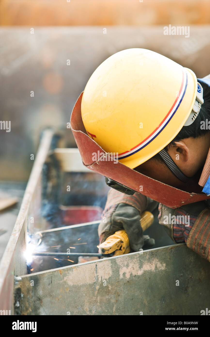 Worker welding metal, side view, close-up Stock Photo - Alamy