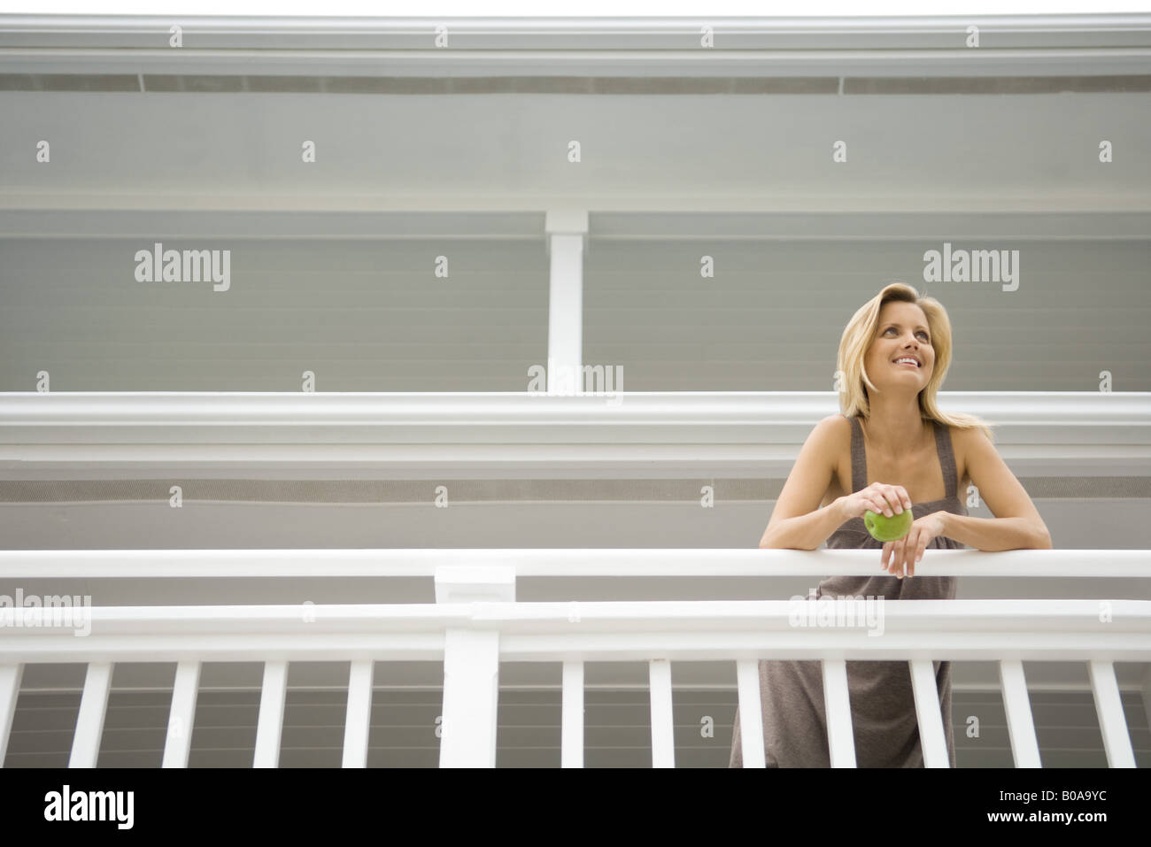 Leaning over balcony young adults hi-res stock photography and images ...