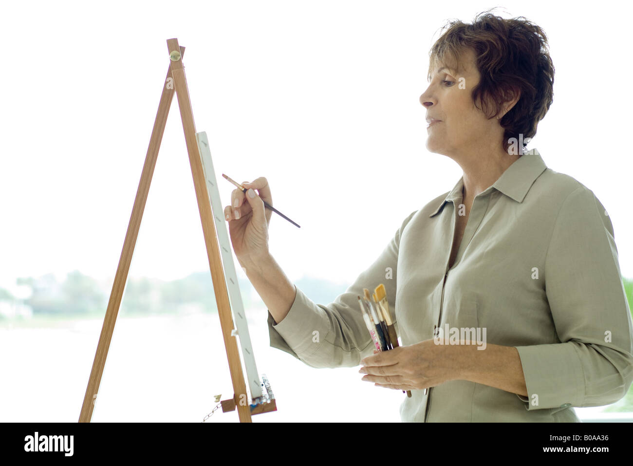 Woman painting on canvas, side view, close-up Stock Photo - Alamy