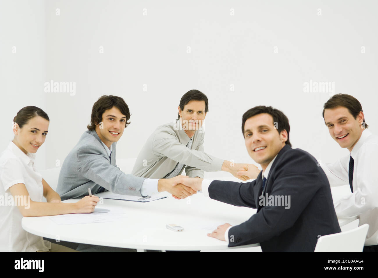 Shaking hands across table hi-res stock photography and images - Alamy