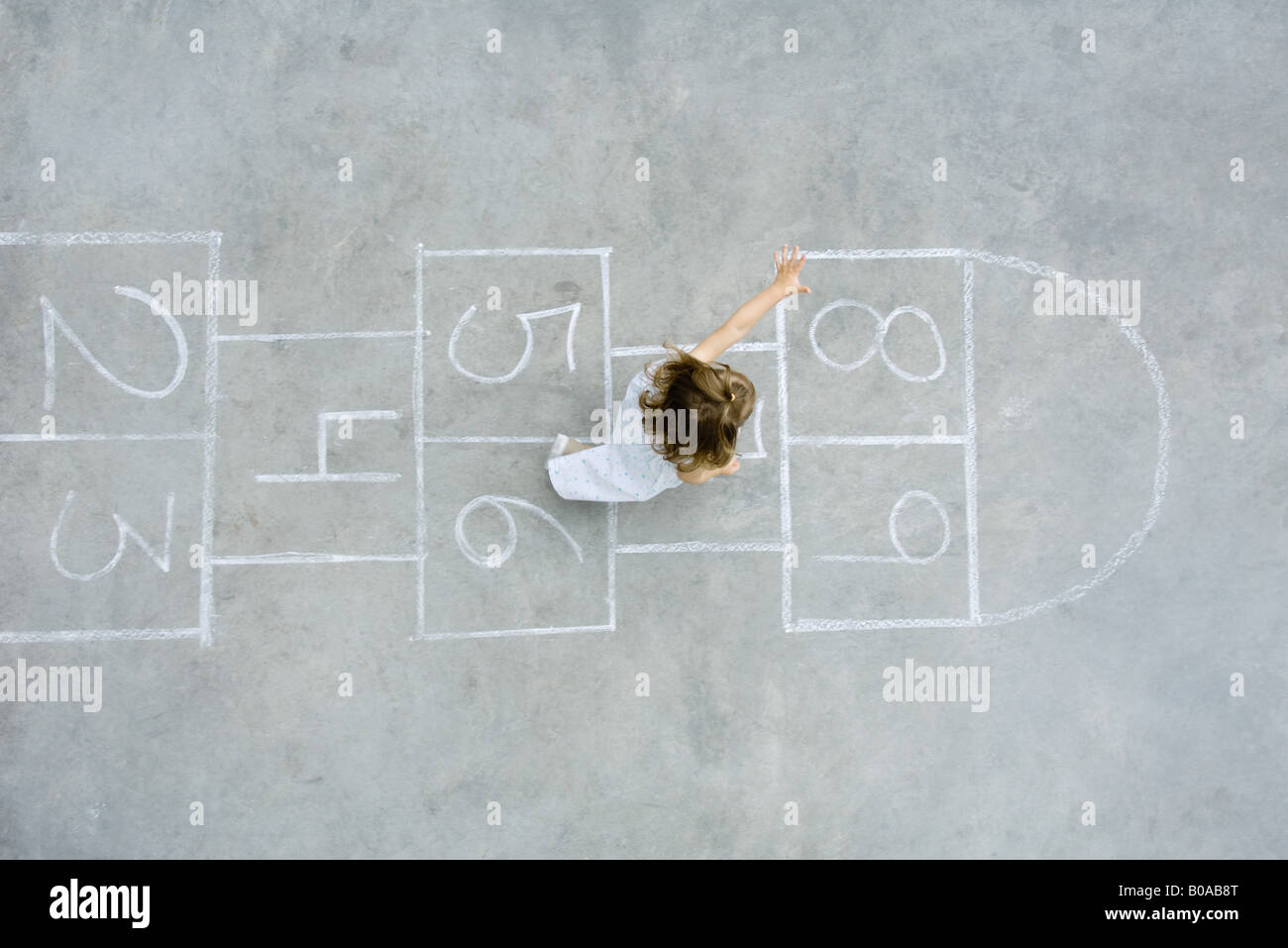Little girl playing hopscotch, overhead view Stock Photo - Alamy