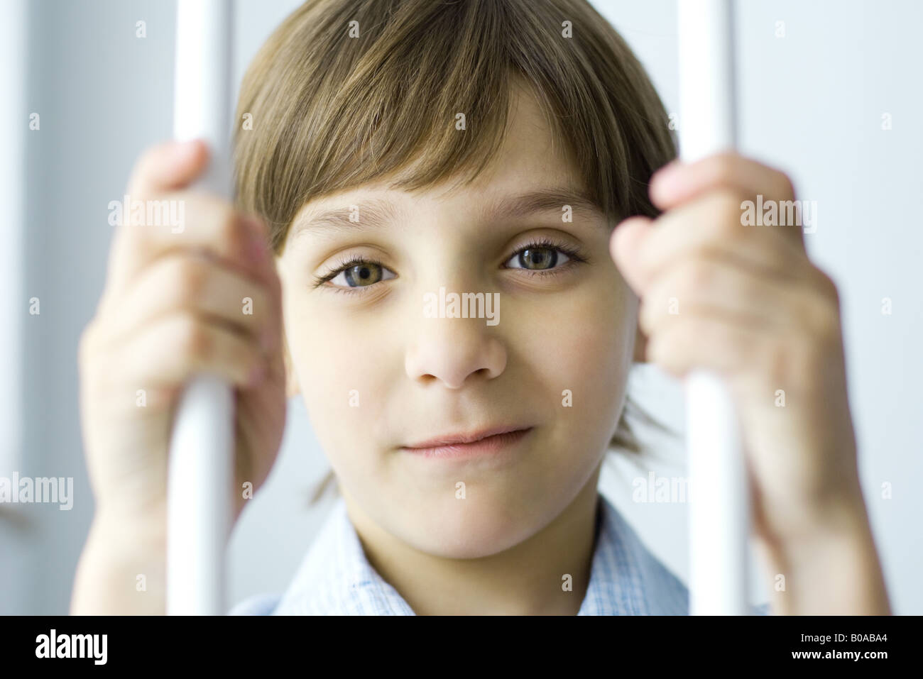 Boy behind bars hi-res stock photography and images - Alamy