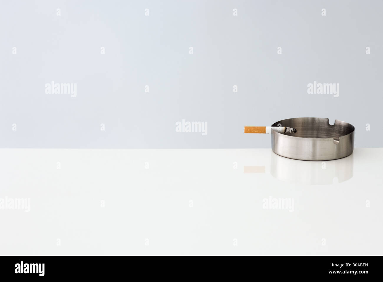Cigarette resting on ashtray Stock Photo - Alamy