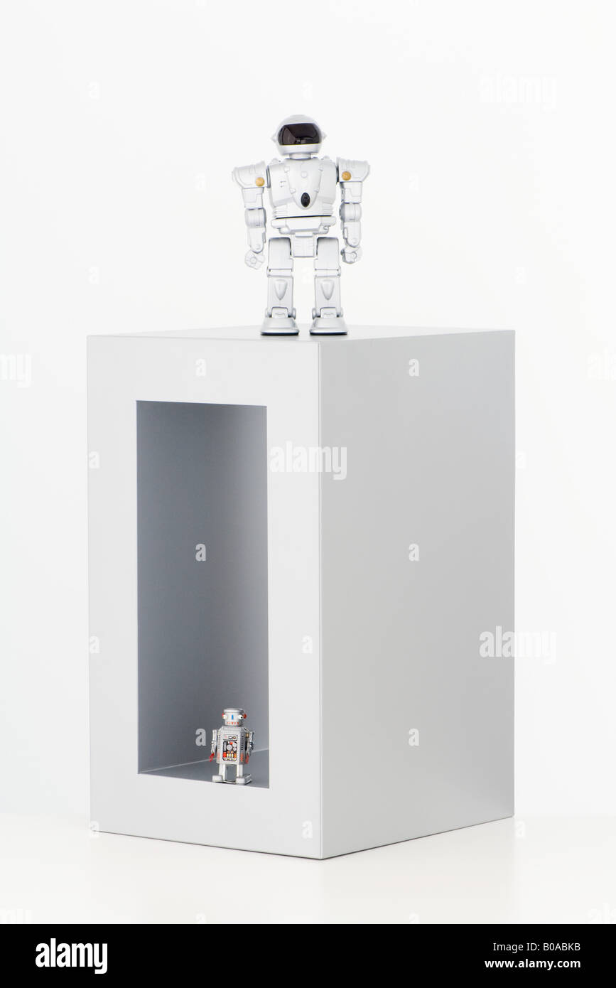 Two robots, one inside box, the other on top of box Stock Photo - Alamy