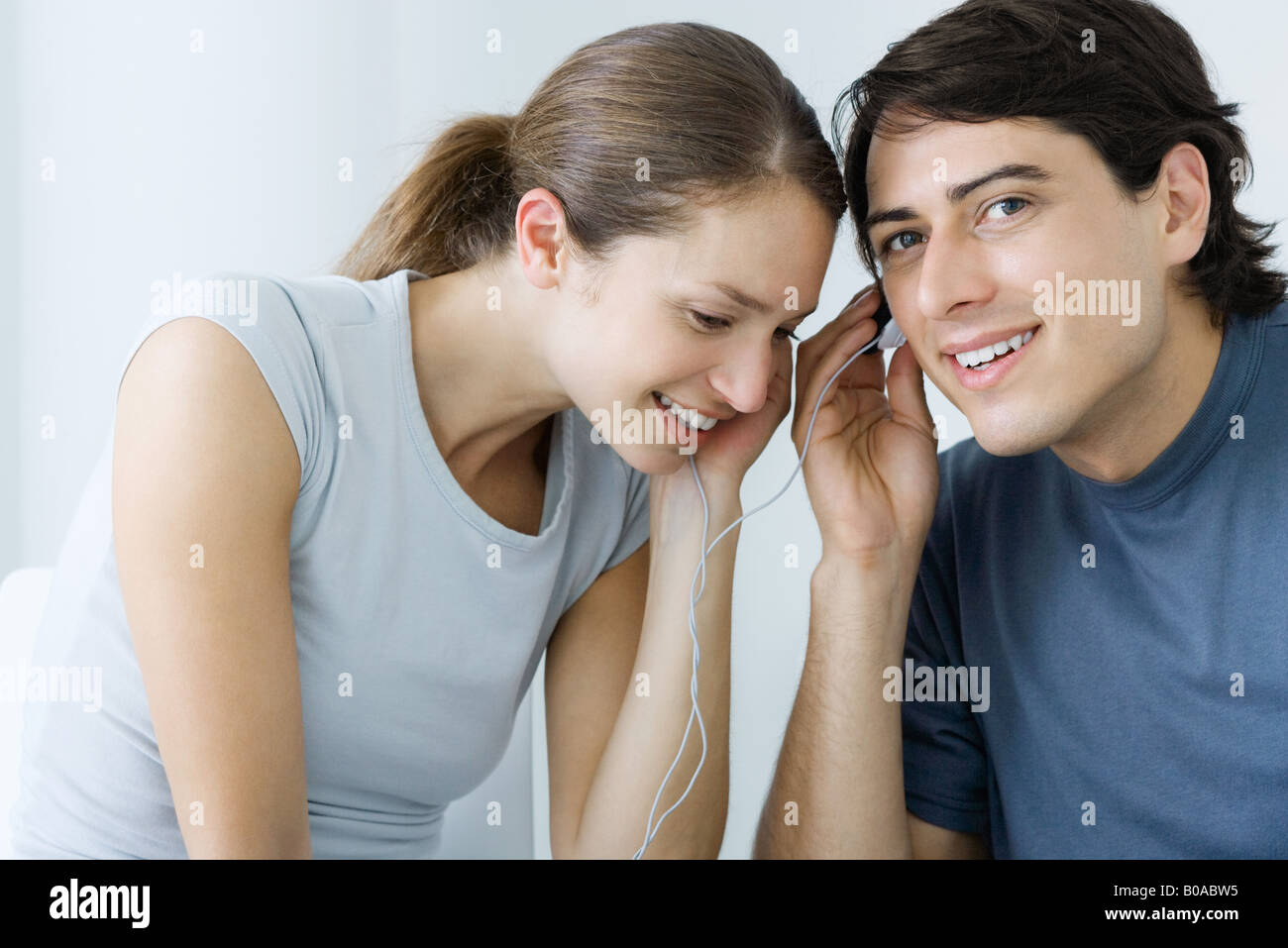 Couple sharing earbuds hi-res stock photography and images - Alamy