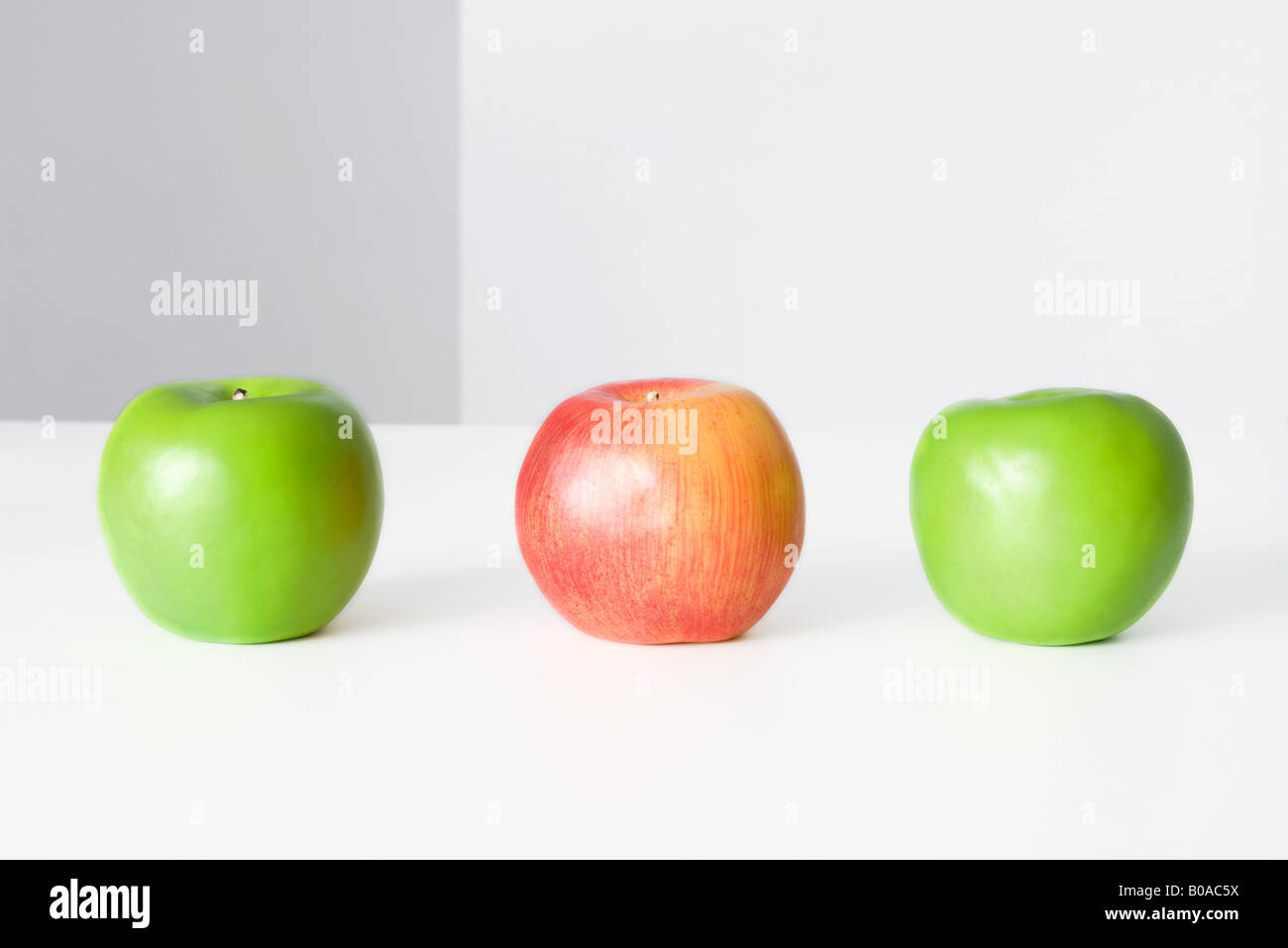 Three apples in a row, two green and one red, close-up Stock Photo - Alamy