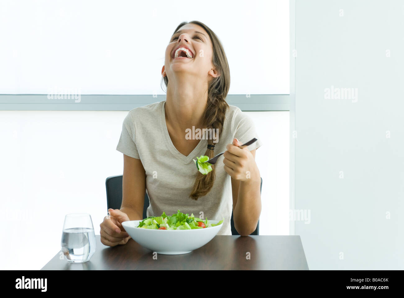Teen girl eating salad laughing hi-res stock photography and images - Alamy