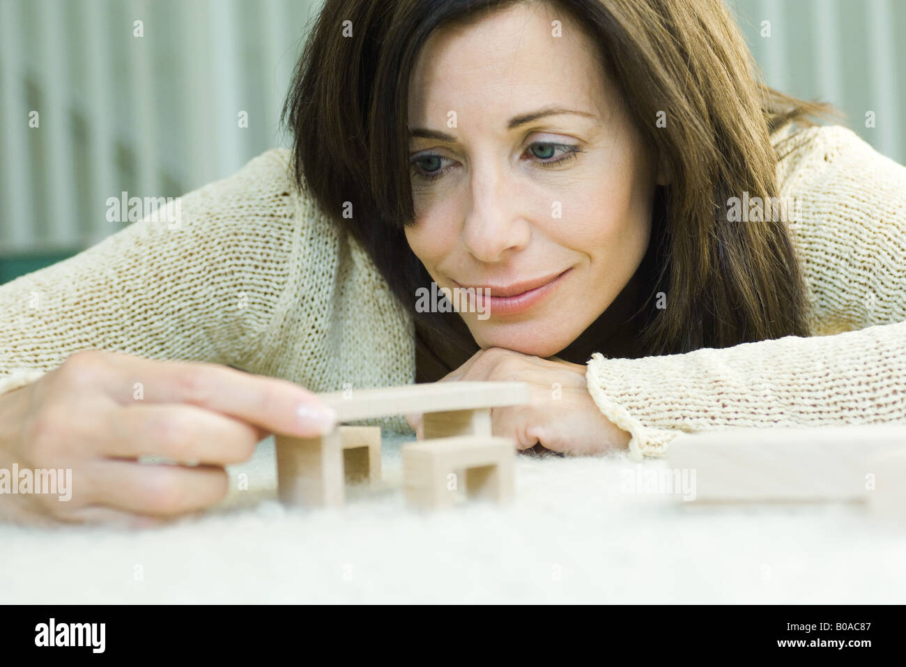 Mature woman playing with building blocks Stock Photo - Alamy