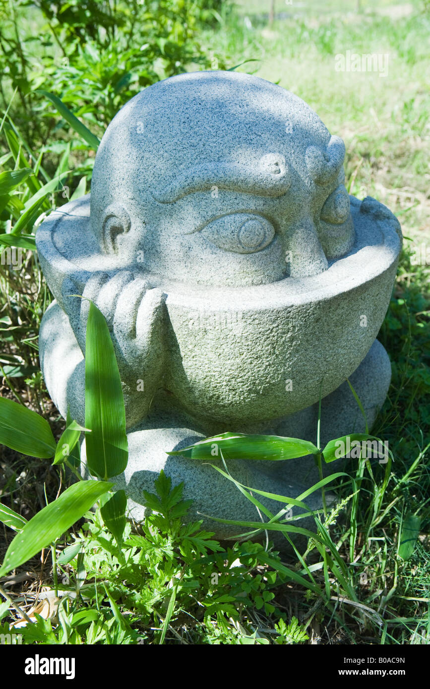 Stone statue in Japanese ornamental garden Stock Photo - Alamy