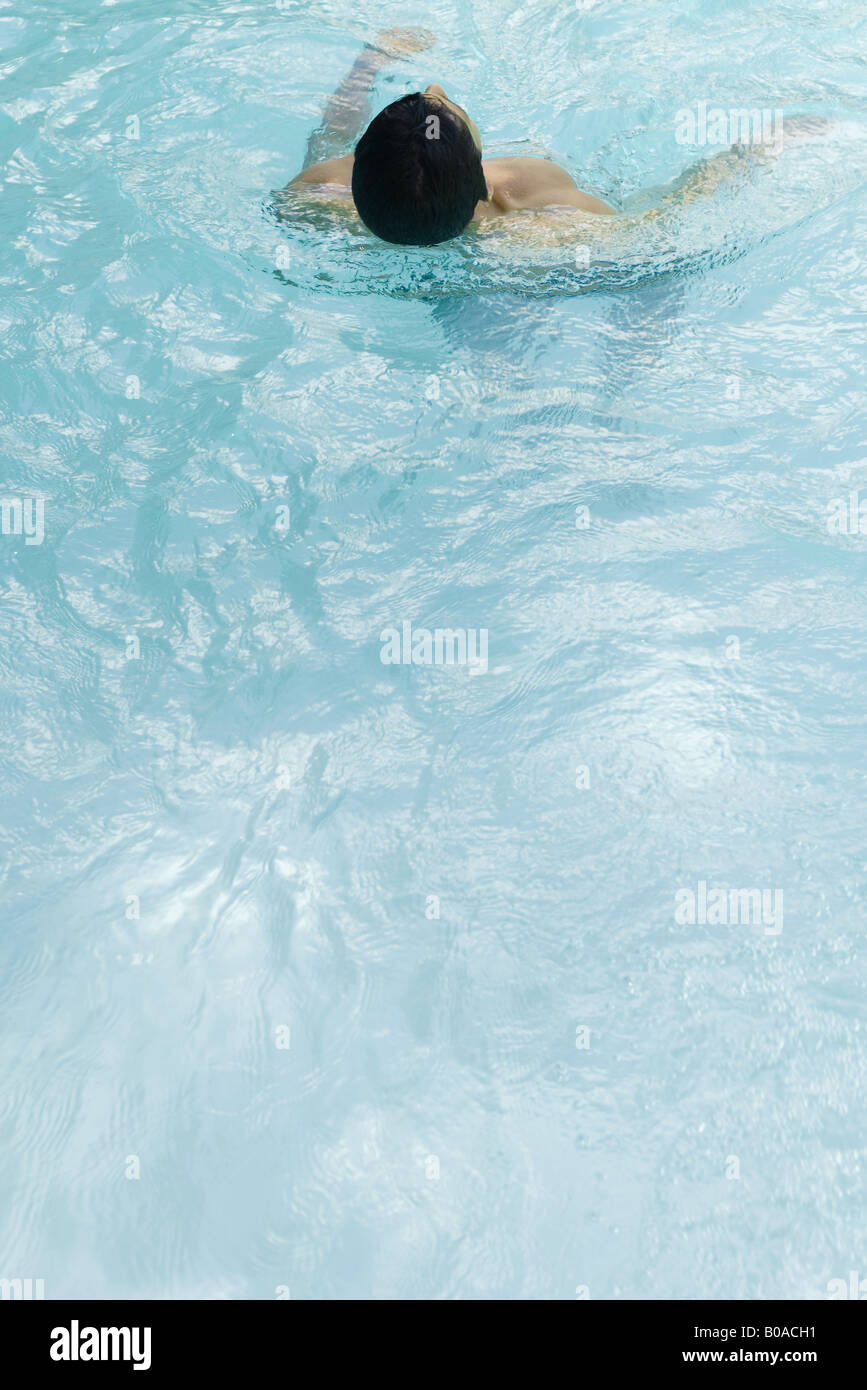 Man in swimming pool, rear view, high angle Stock Photo - Alamy