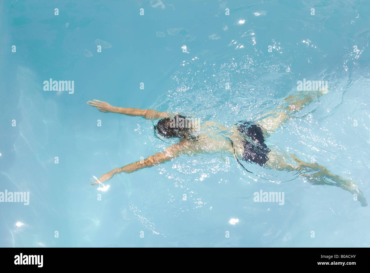 Man swimming in pool, rear view, high angle Stock Photo - Alamy