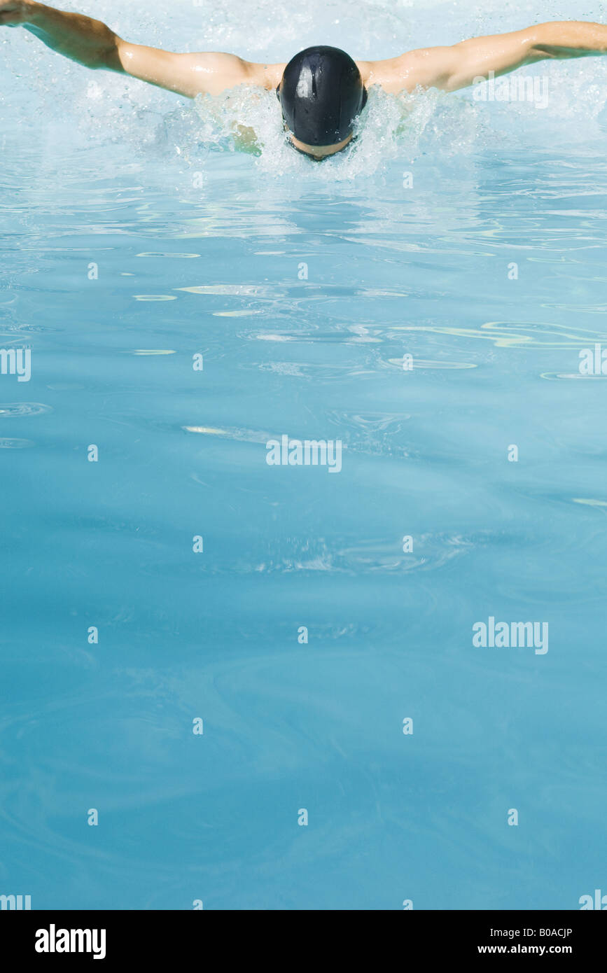 Swimmer doing butterfly stroke in pool Stock Photo - Alamy
