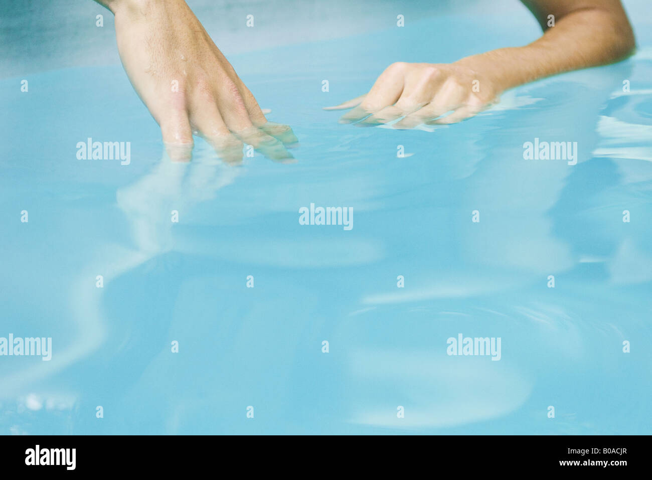 Man dipping hands in water, close-up, cropped Stock Photo - Alamy