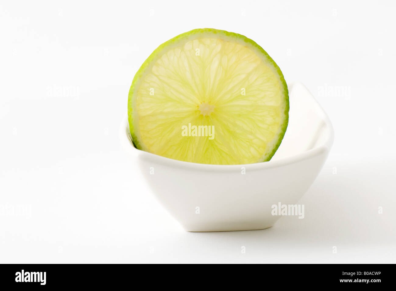 Slice of lime in small dish Stock Photo - Alamy