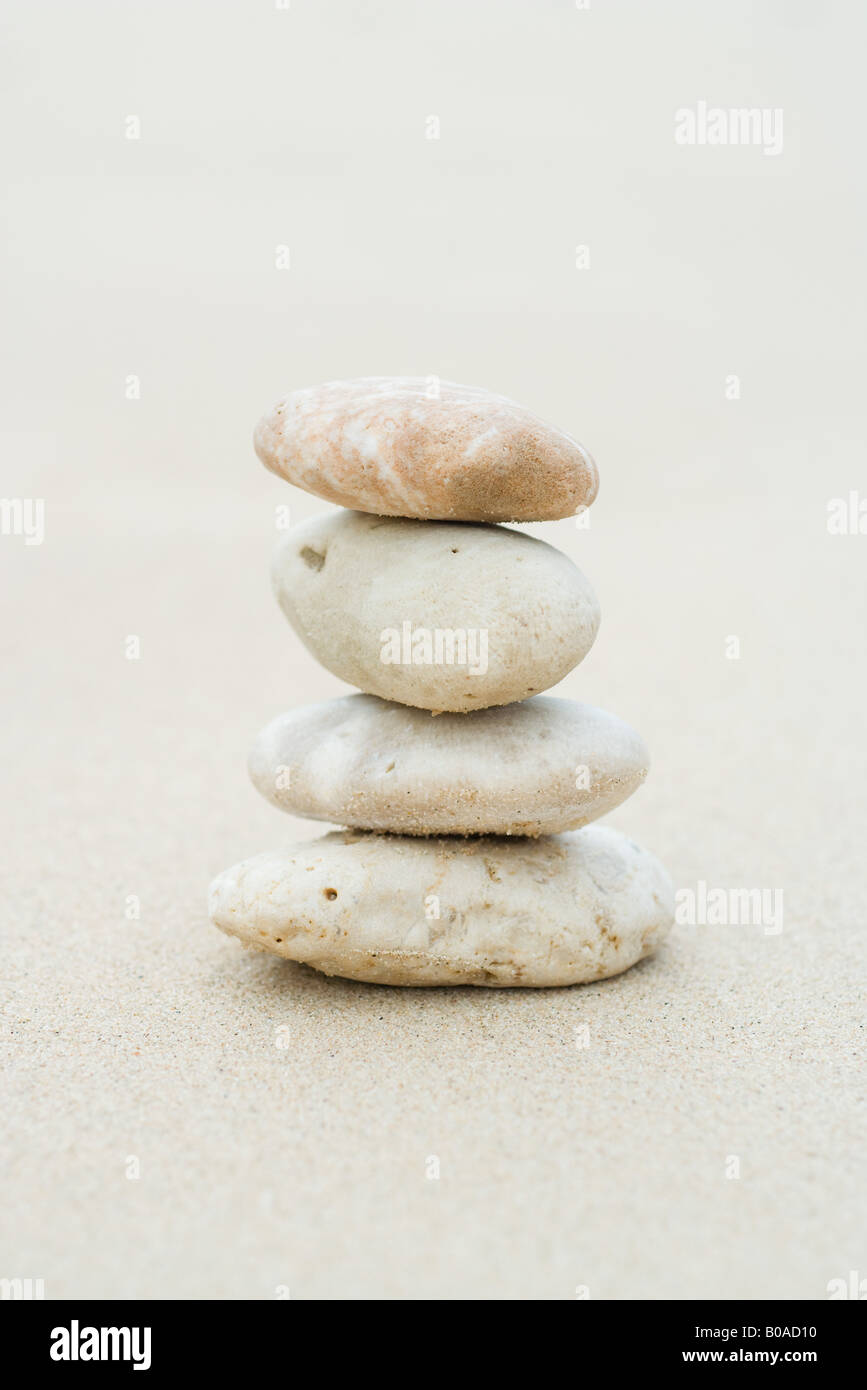 Pebbles stacked on sand, close-up Stock Photo - Alamy