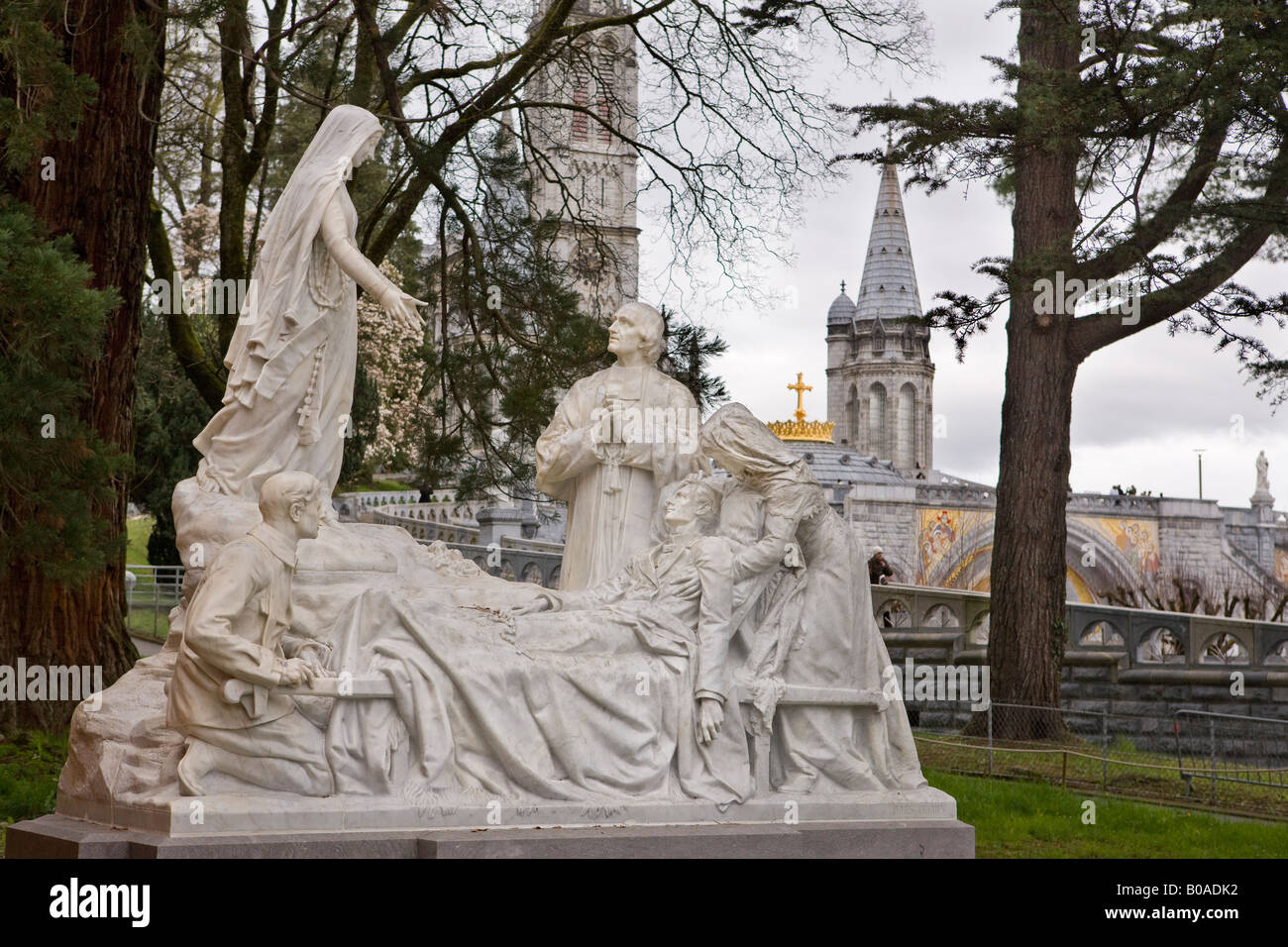 White marble statue in a park in Lourdes showing a healing miracle by ...