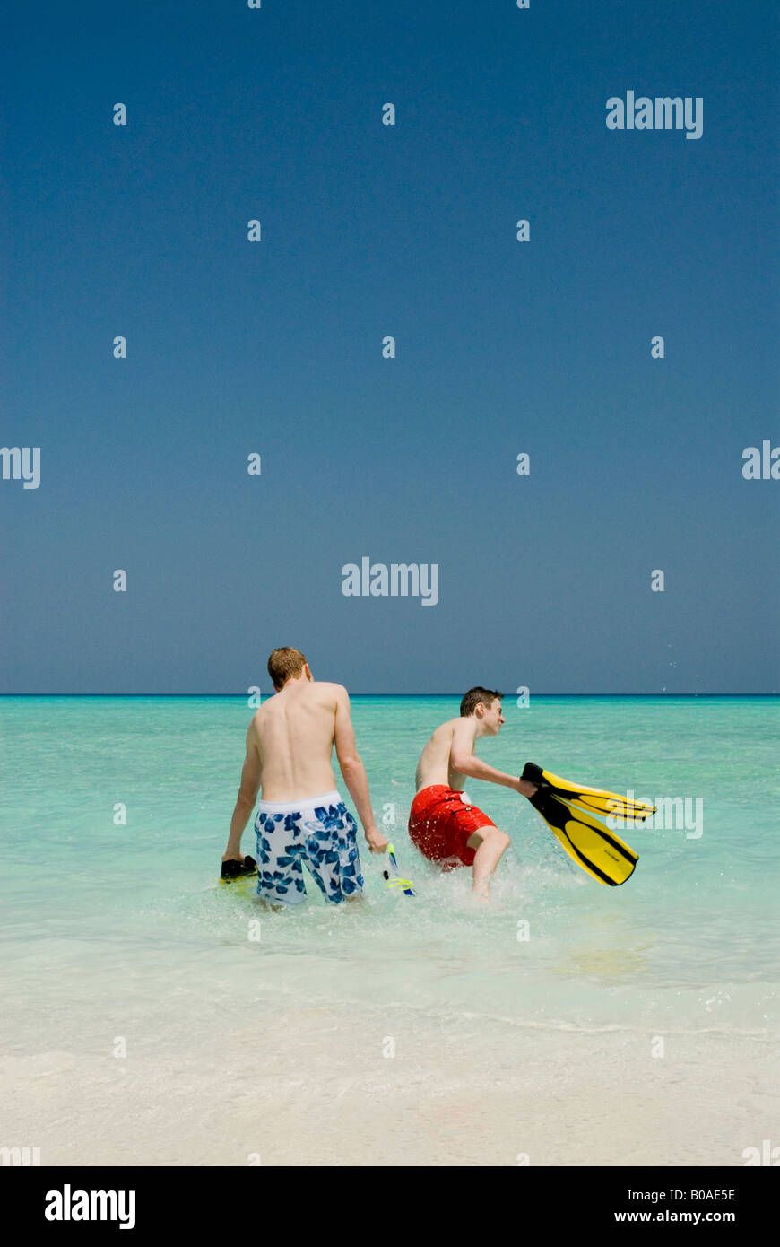 Two boys jumping into the sea hi-res stock photography and images - Alamy
