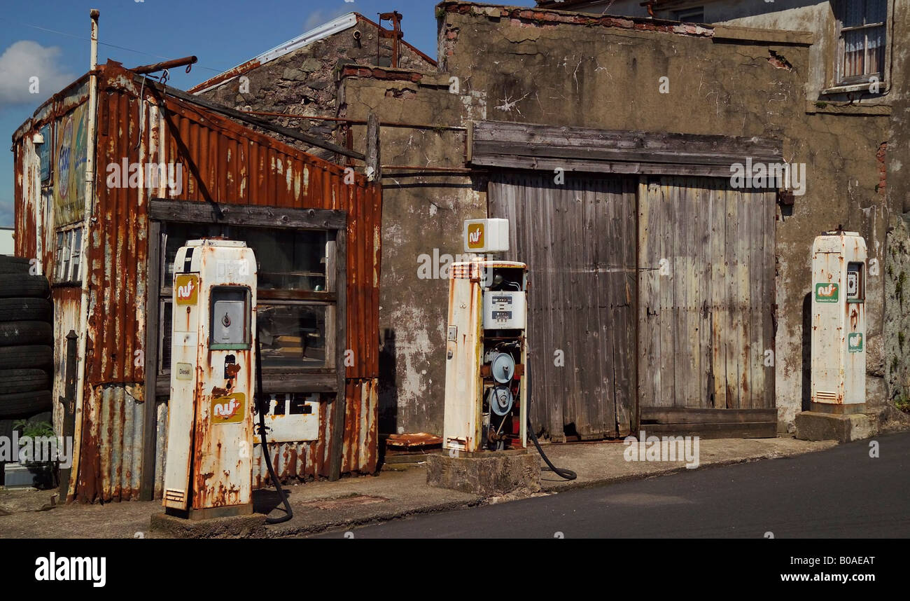 A derelict old petrol station with rusty old petrol pumps Stock Photo ...