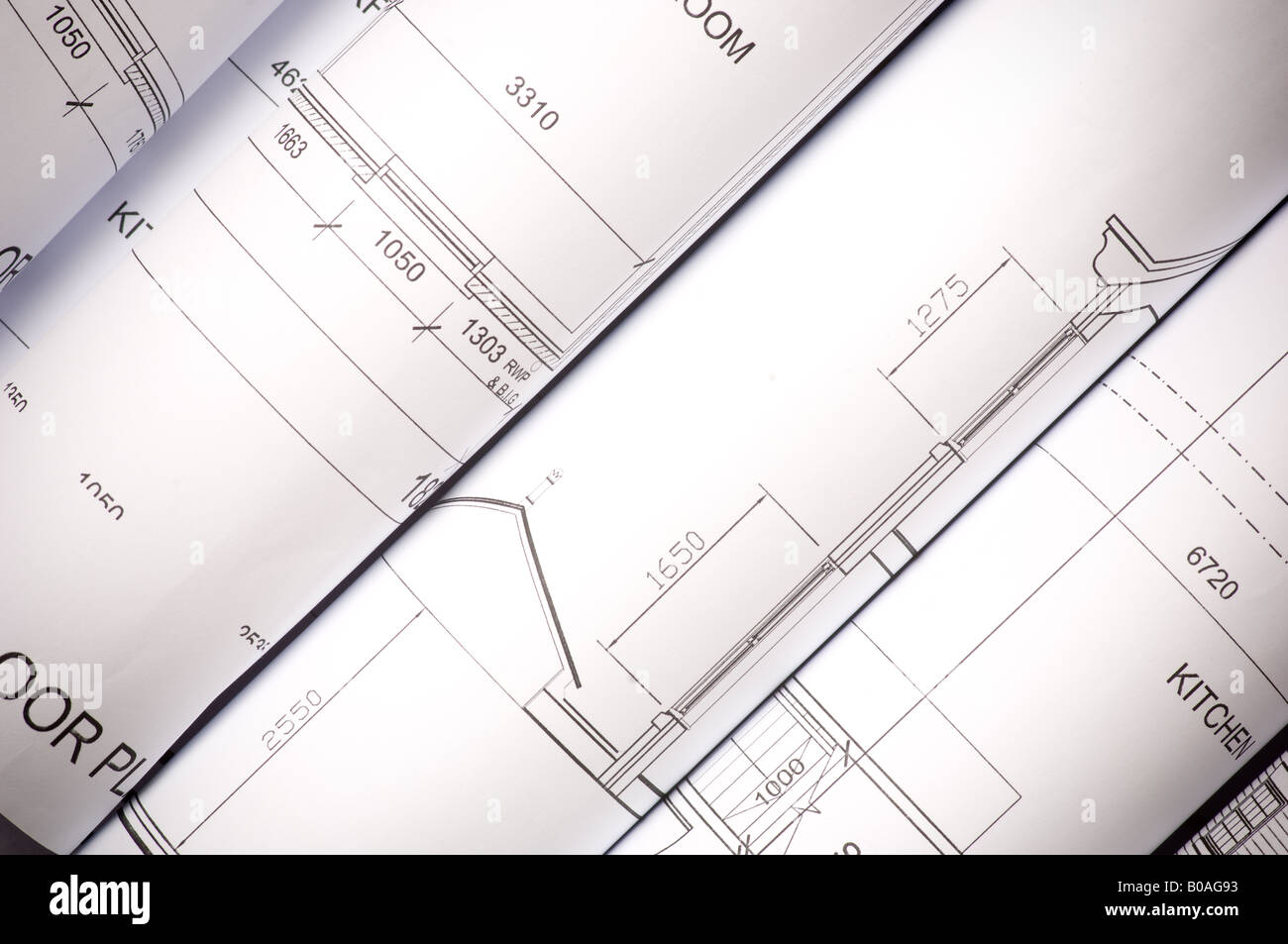 Closeup of rolled up paper copies of architectural floor plans for a ...